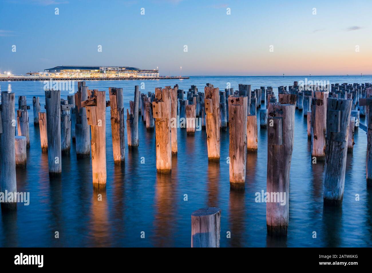 Illuminated old wooden pylons of historic Princes Pier in Port ...