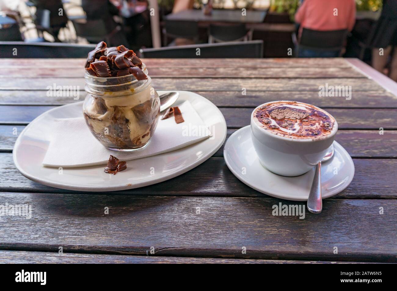 Appetizing chocolate dessert and cup of coffee on wooden table in ...