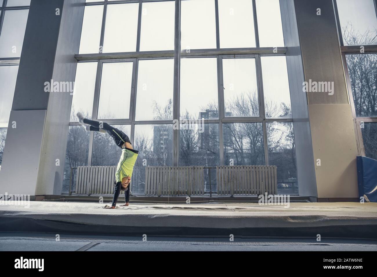 Flying. Little male gymnast training in gym, flexible and active ...