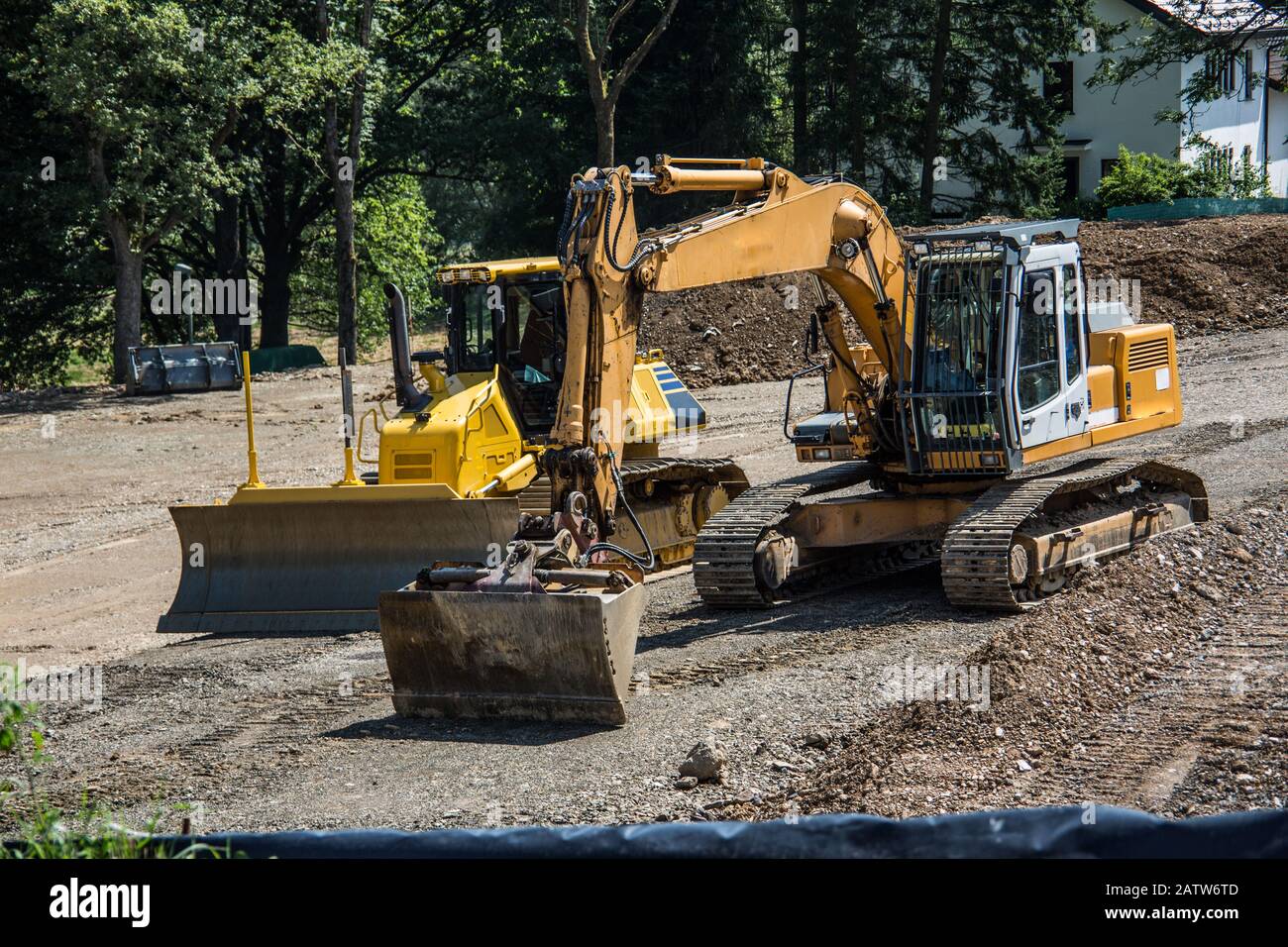 yellow construction machinery on construction site Stock Photo - Alamy