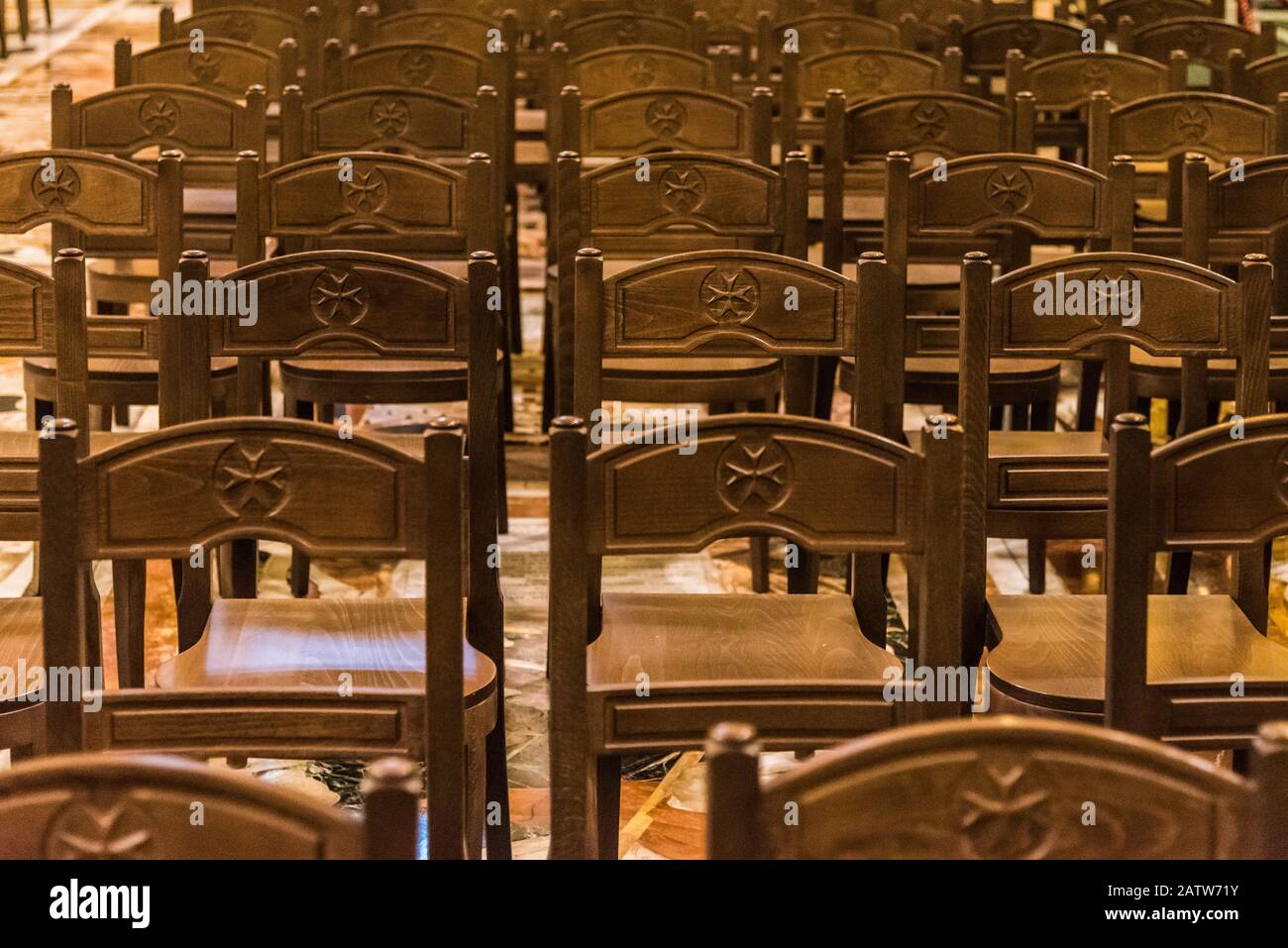 Empty chairs in the church with Maltese emblem Stock Photo - Alamy