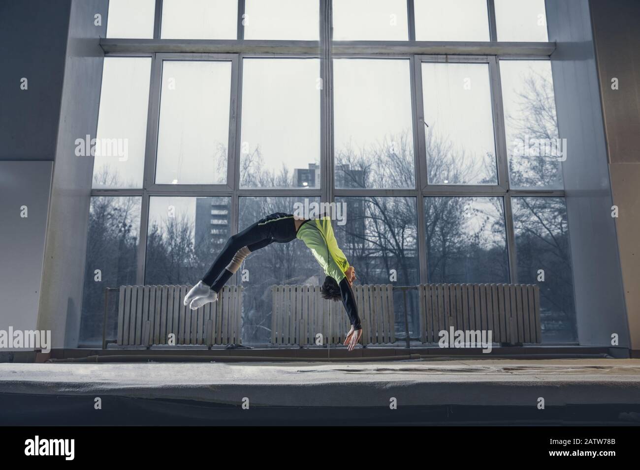 Flying. Little male gymnast training in gym, flexible and active ...
