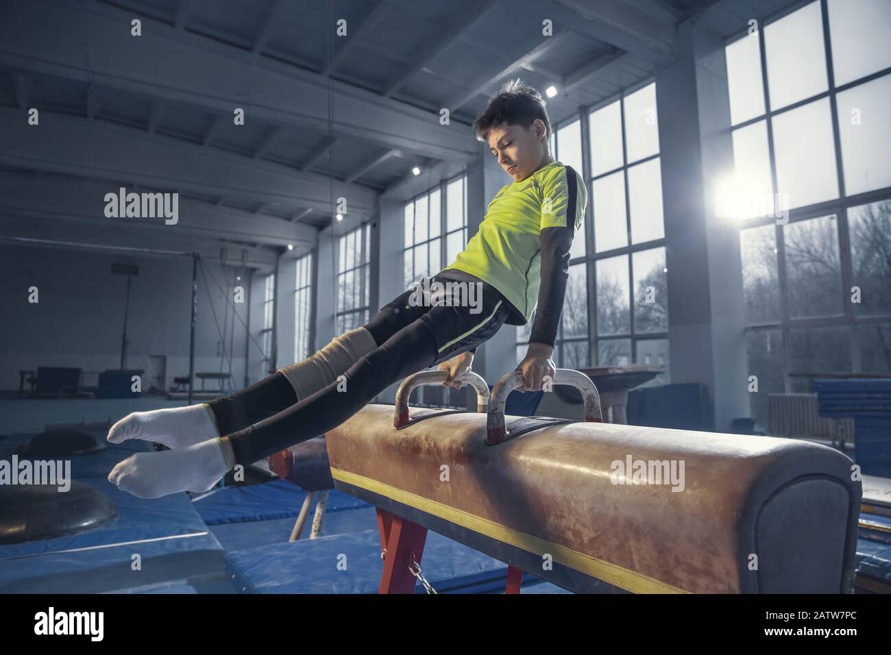 Control. Little male gymnast training in gym, flexible and active ...