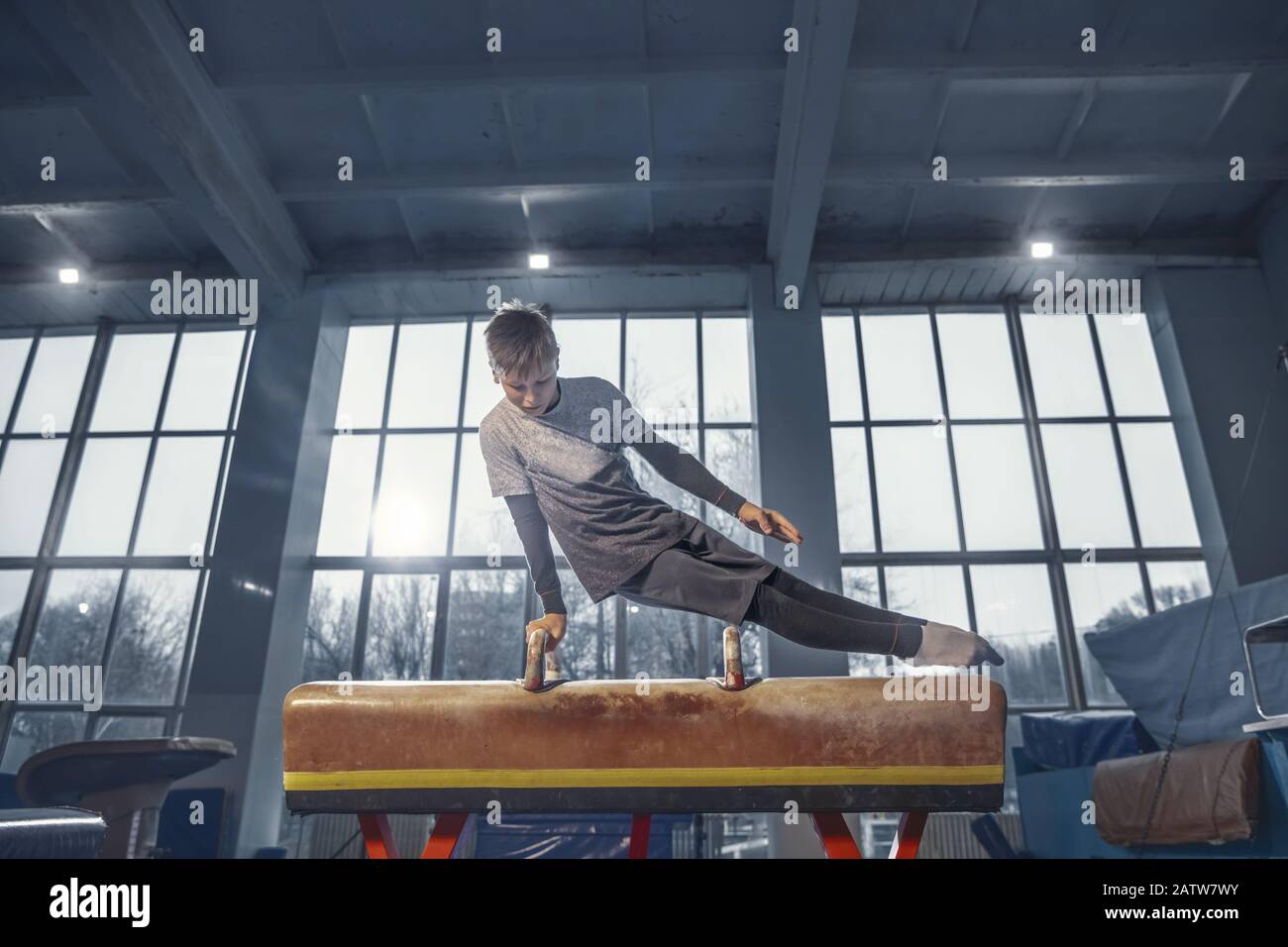 Control. Little male gymnast training in gym, flexible and active ...