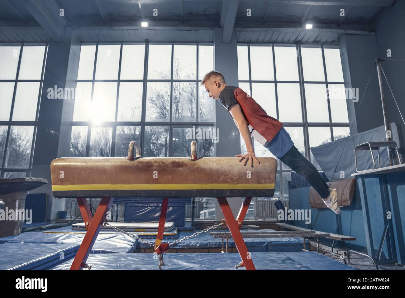 Grace. Little male gymnast training in gym, flexible and active ...
