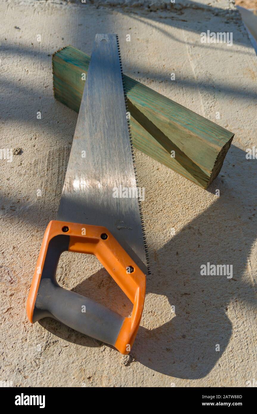Hand saw on wooden block construction, building still life background ...