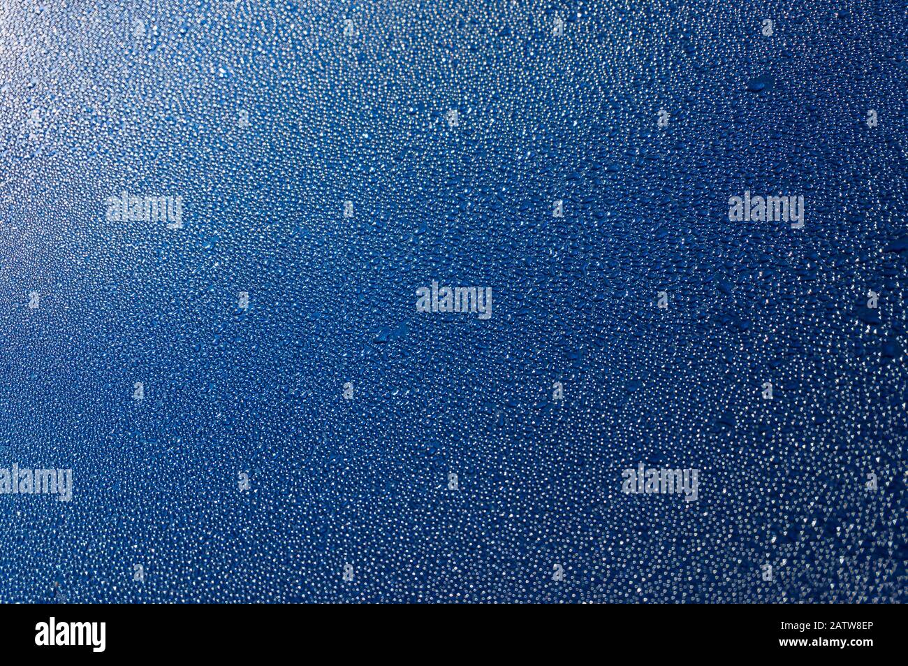 Blue metallic surface covered with water droplets texture, abstract ...