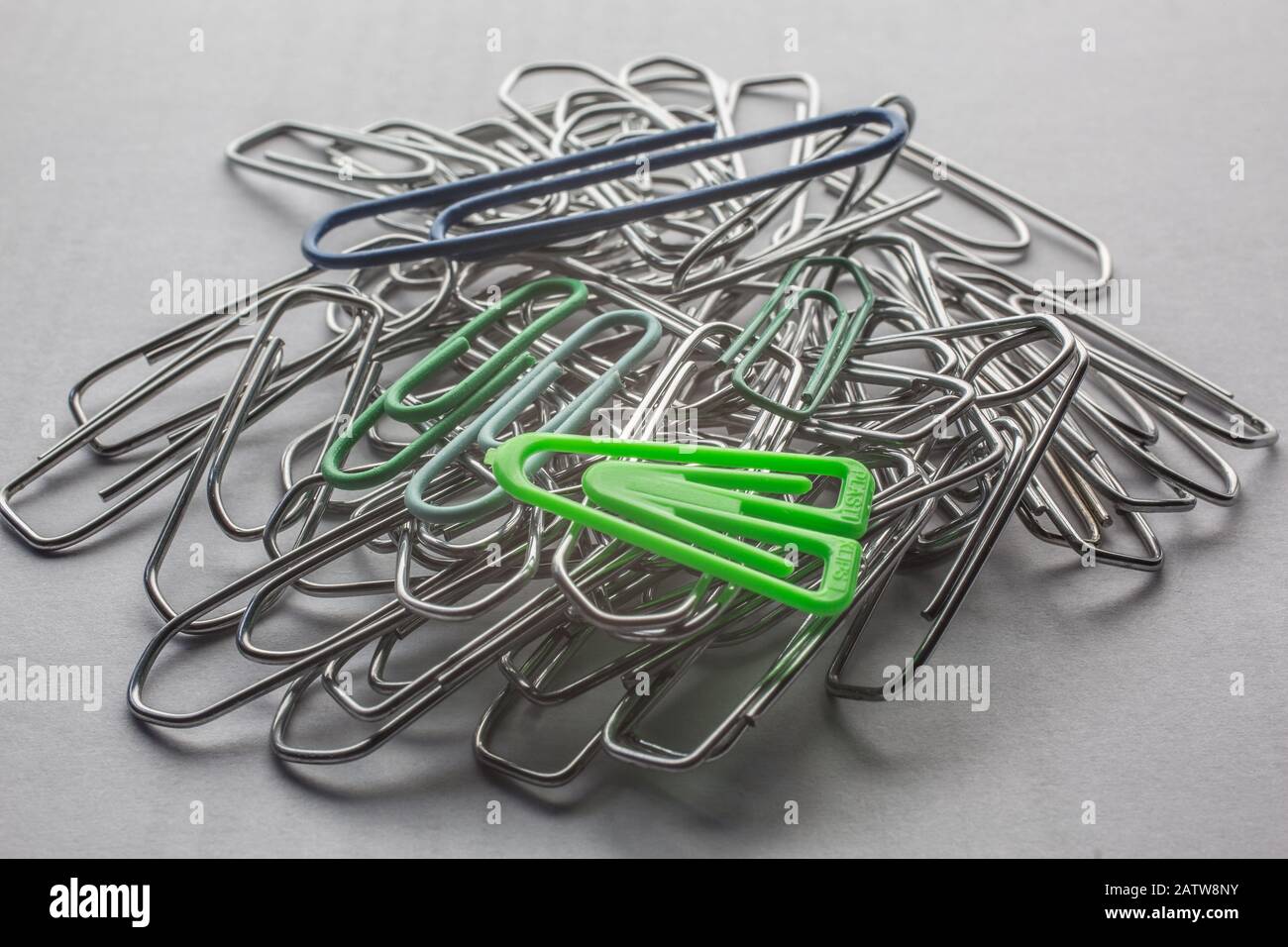 metallic silvery paper clips on a pile Stock Photo - Alamy