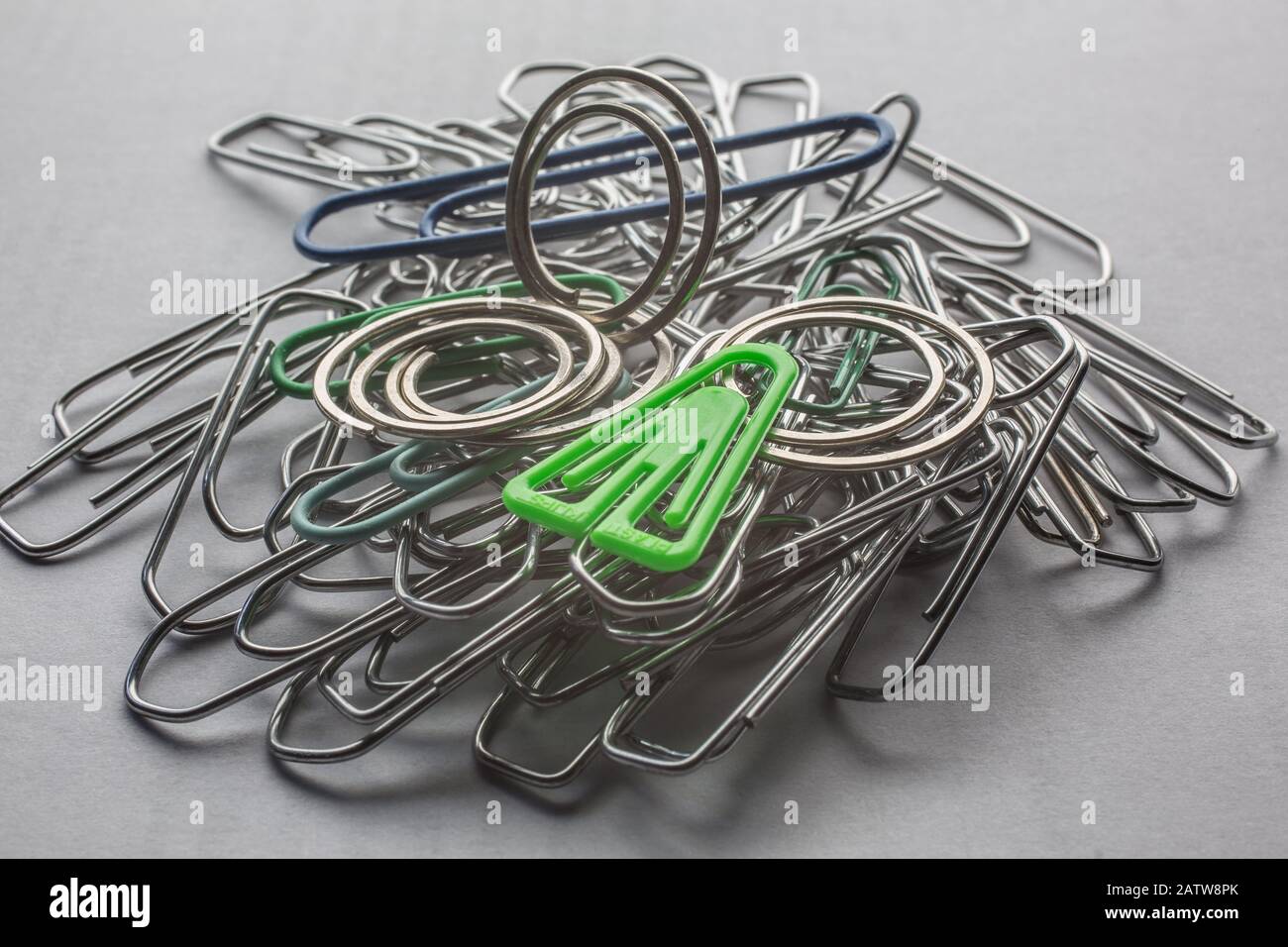 metallic silvery paper clips on a pile Stock Photo - Alamy