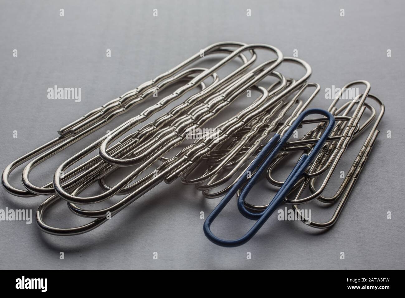 metallic silvery paper clips on a pile Stock Photo - Alamy