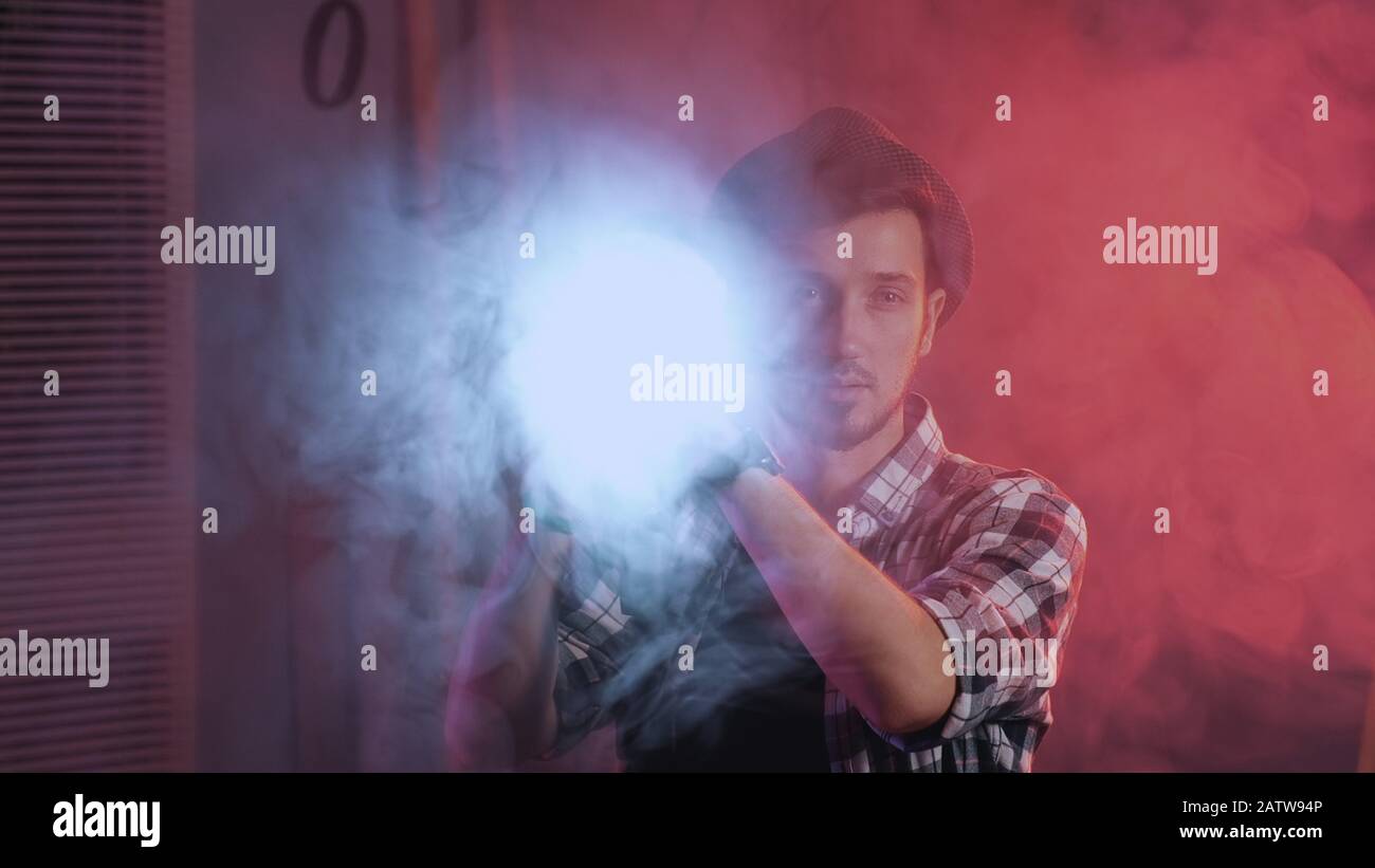 Close-up of technicians in the filmmaking lighting the lamp and smiling ...