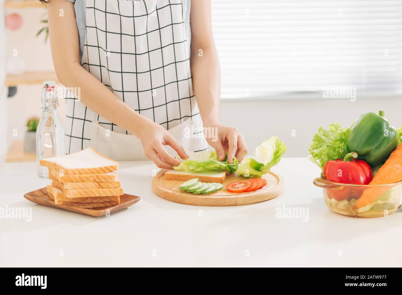 Mother preparing sandwich for school lunch on table Stock Photo - Alamy
