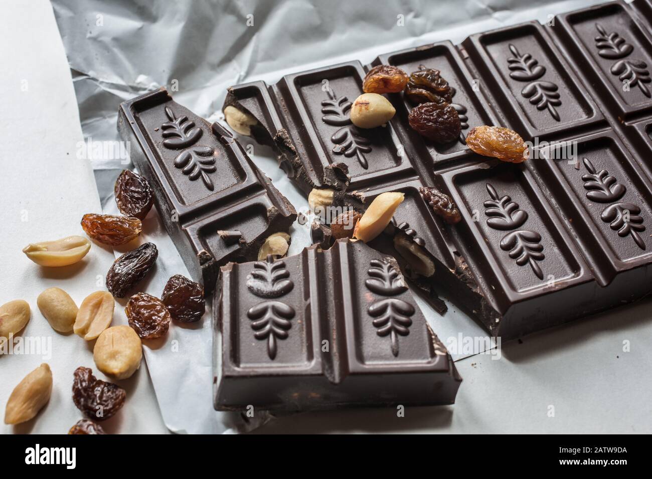 Chocolate bar with nuts and grapes Stock Photo - Alamy