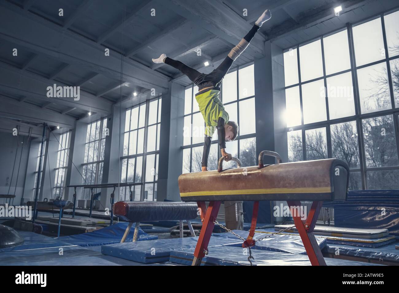 Champion. Little male gymnast training in gym, flexible and active ...