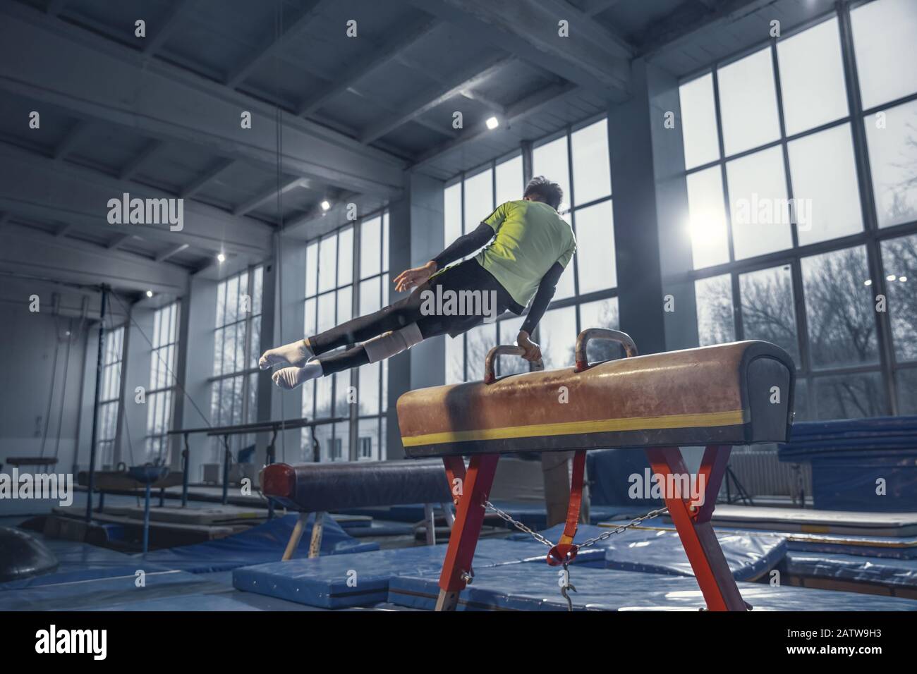 Champion. Little male gymnast training in gym, flexible and active ...