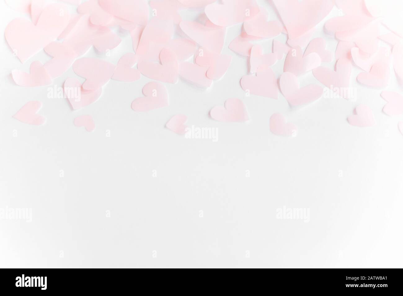 Cute pink pastel hearts border on white paper background with copy ...