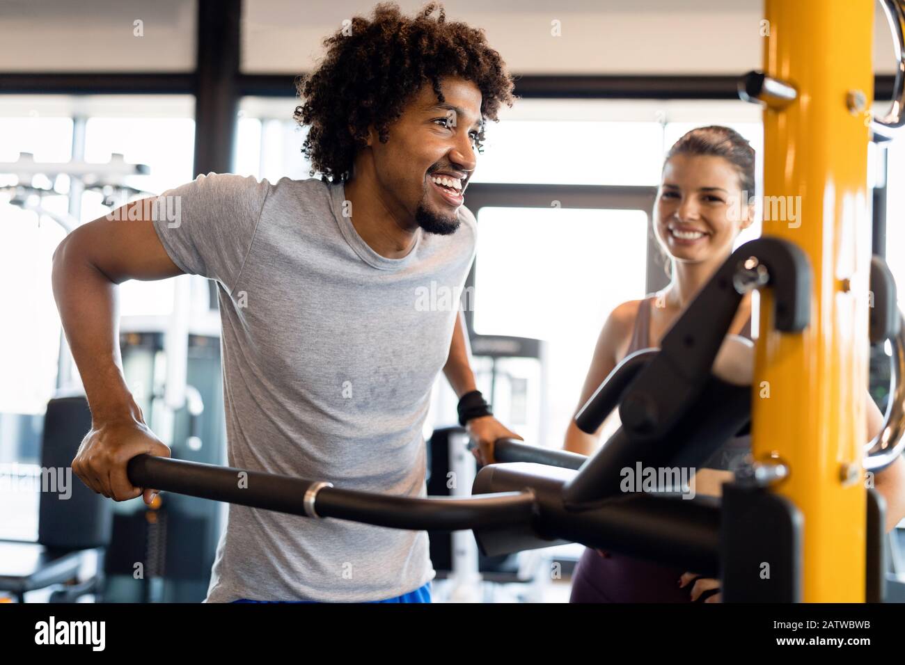 Teamwork in gym. Couple working exercise together Stock Photo - Alamy