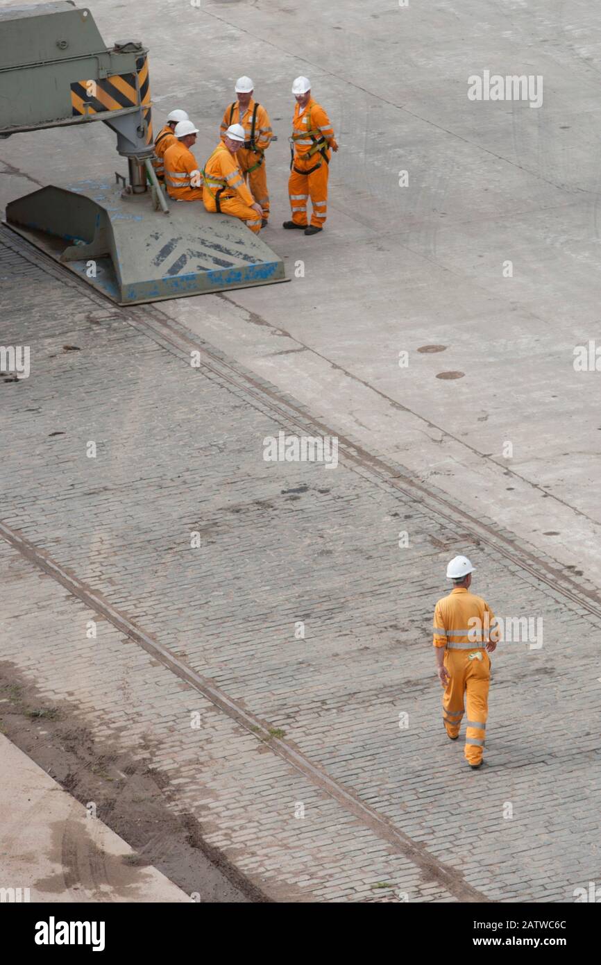 Workers having a break at the dockside Stock Photo - Alamy