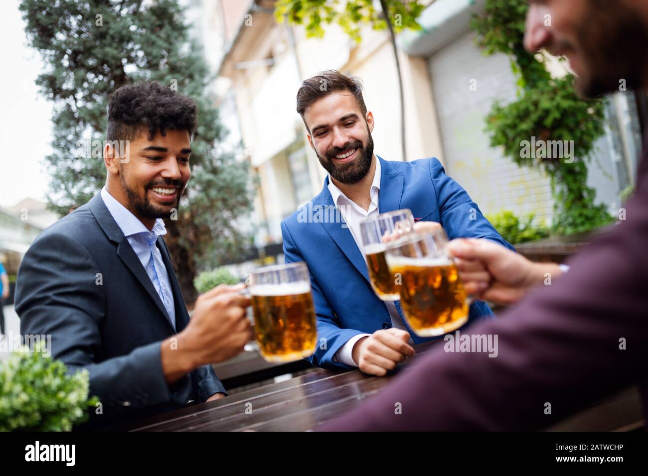 Meeting with the best friends. Happy young business men talking and ...