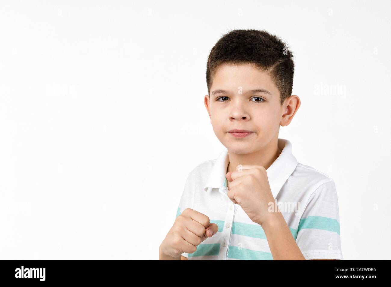angry little child boy mad raising fist over white background. Human ...