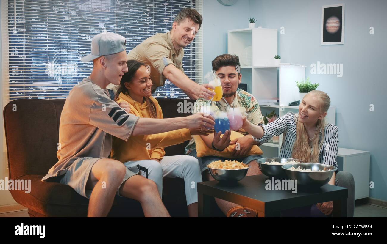 Medium close up of happy friends cheers with each other with dry ice ...