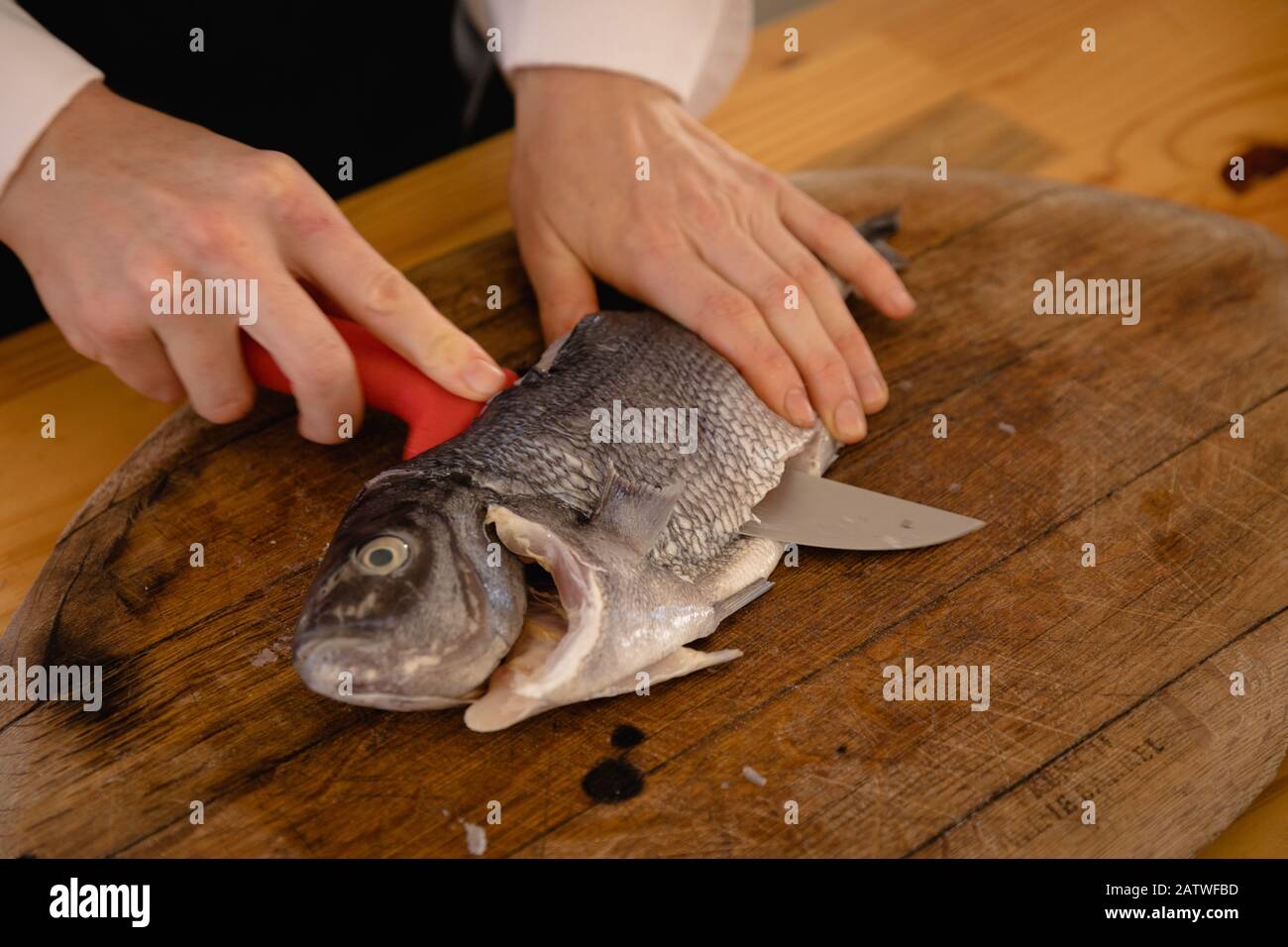 Chef cooking a fish Stock Photo - Alamy