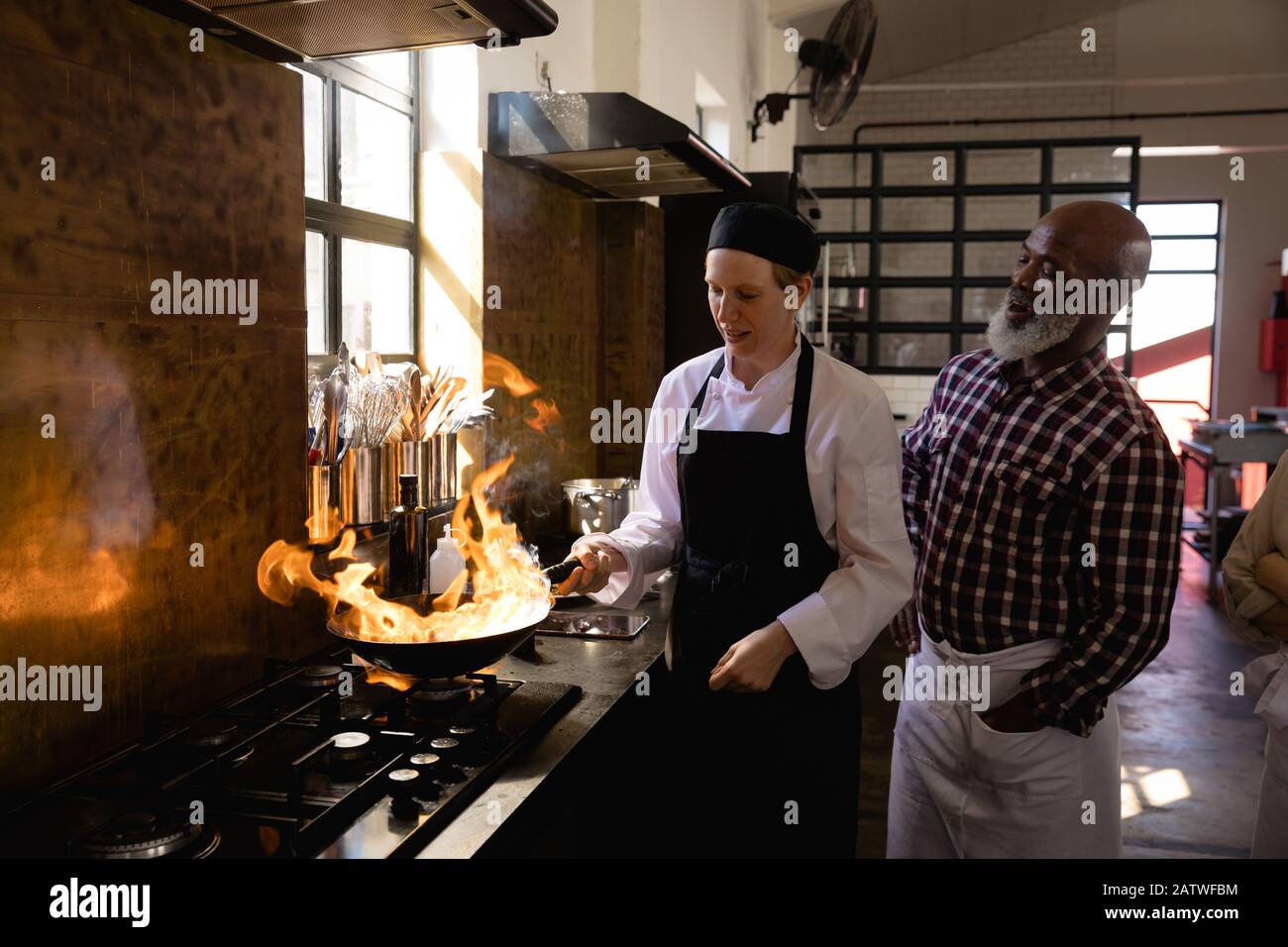 Chefs cooking with fire Stock Photo - Alamy