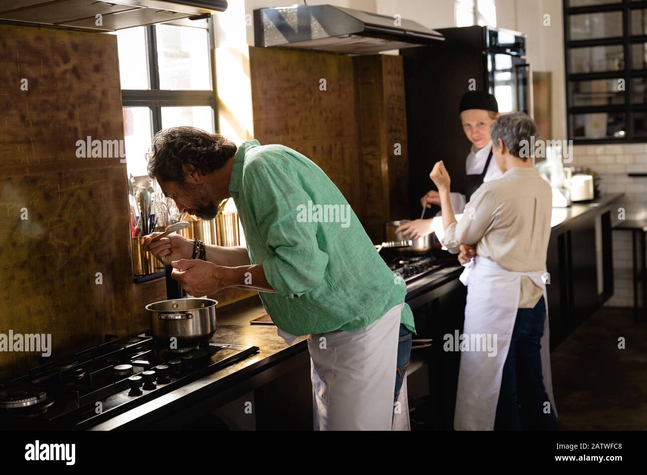 Chefs cooking together Stock Photo - Alamy