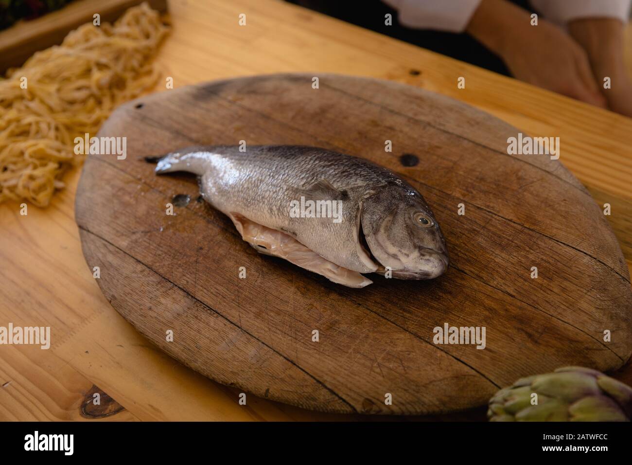 Chef cooking a fish Stock Photo - Alamy