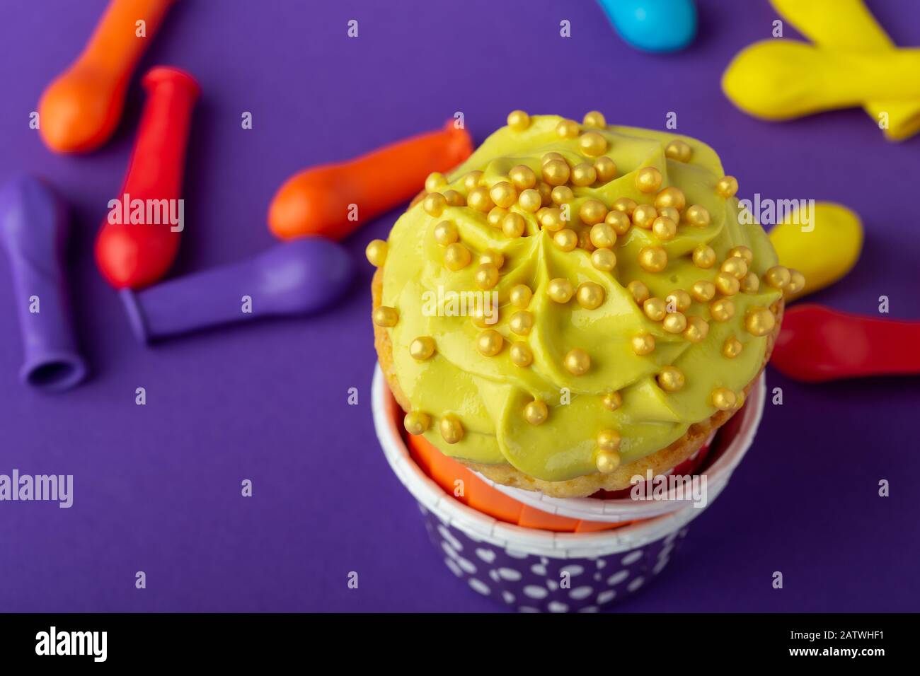 Birthday cupcake in funny polka dot colorful cups stack and deflated ...