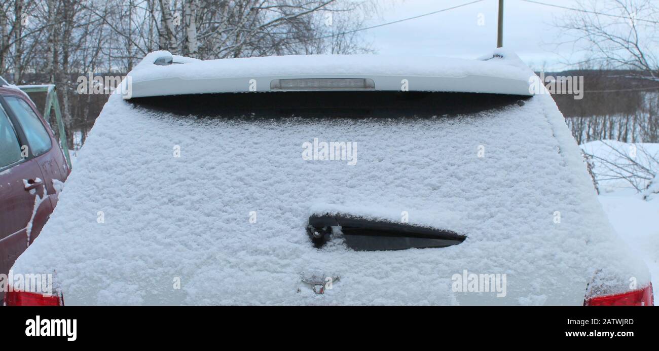 Car in modern style on white background with snow on glass. Winter ...
