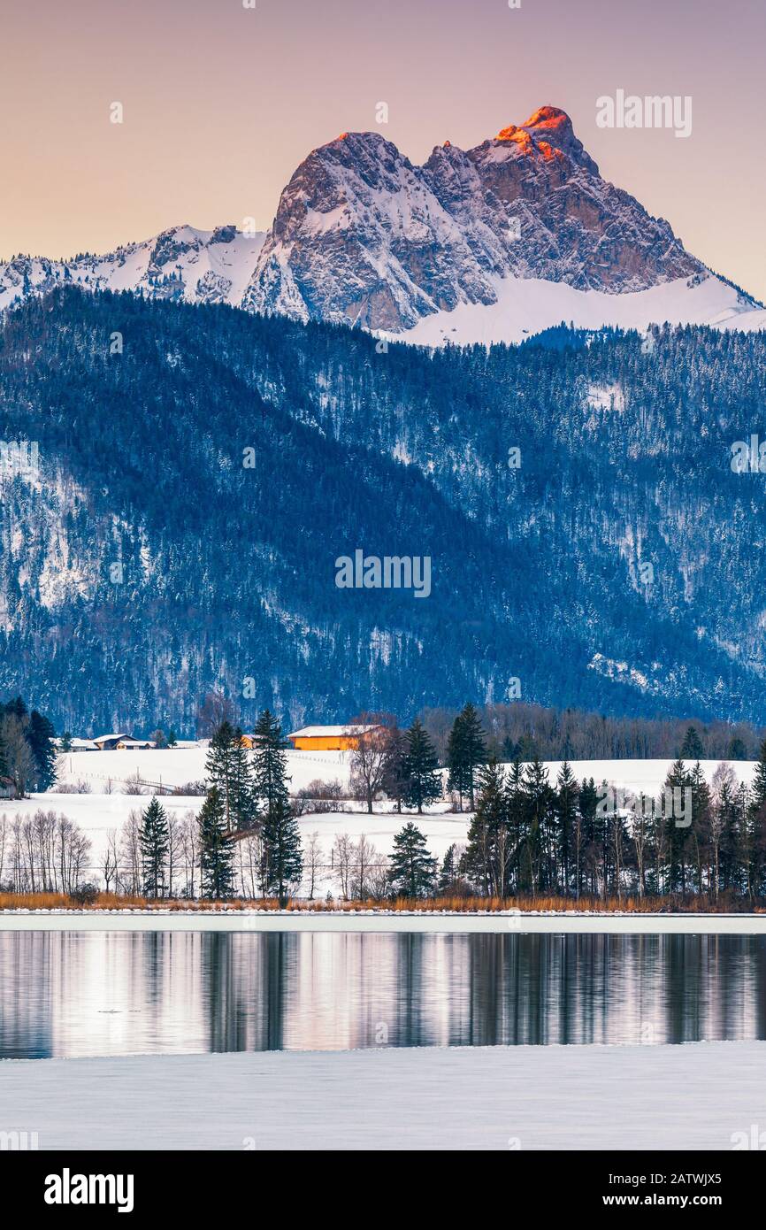Winter sunrise at Lake Hopfen with the Karwendel mountains in the ...