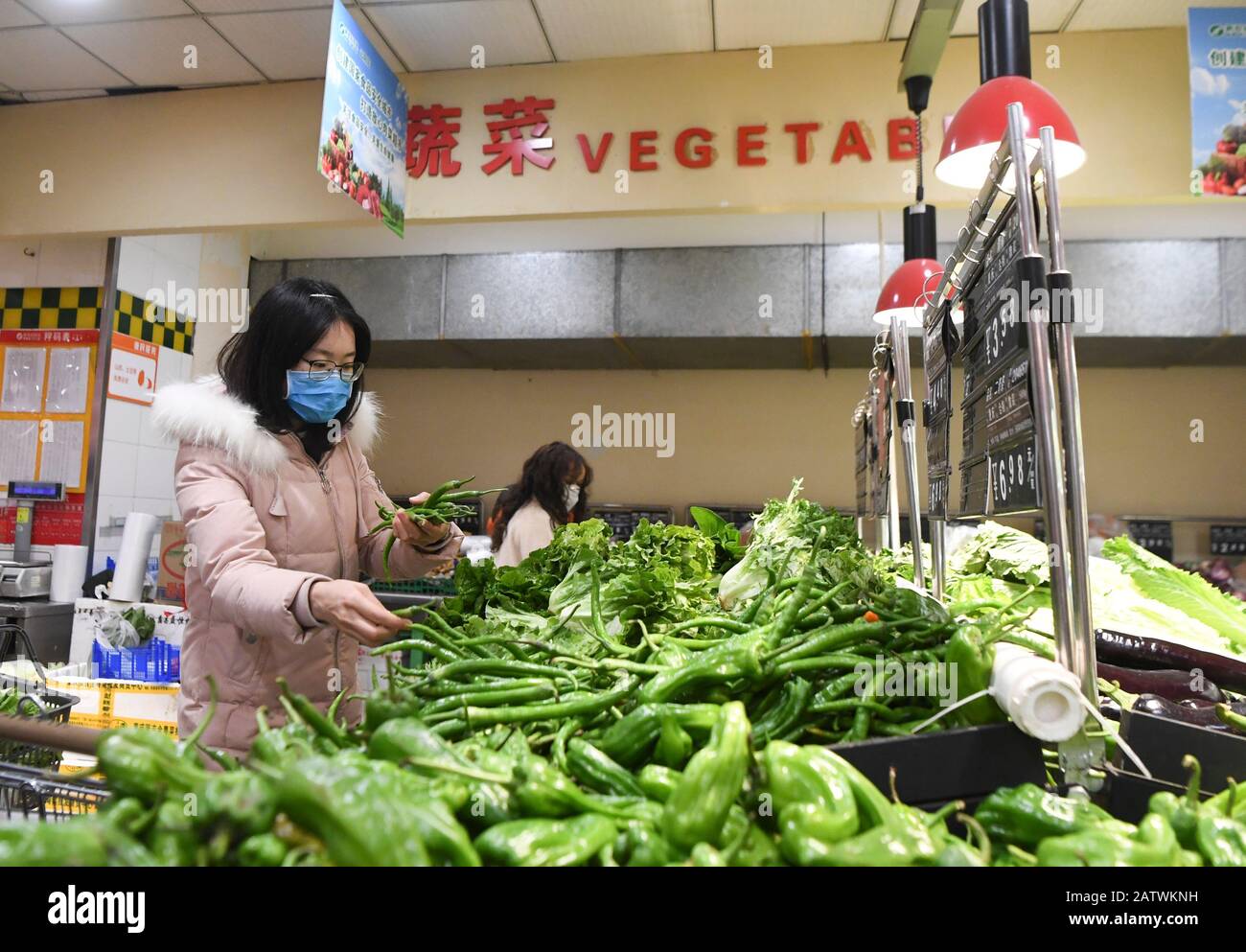 Chongqing. 5th Feb, 2020. People buy vegetables in a supermarket in ...