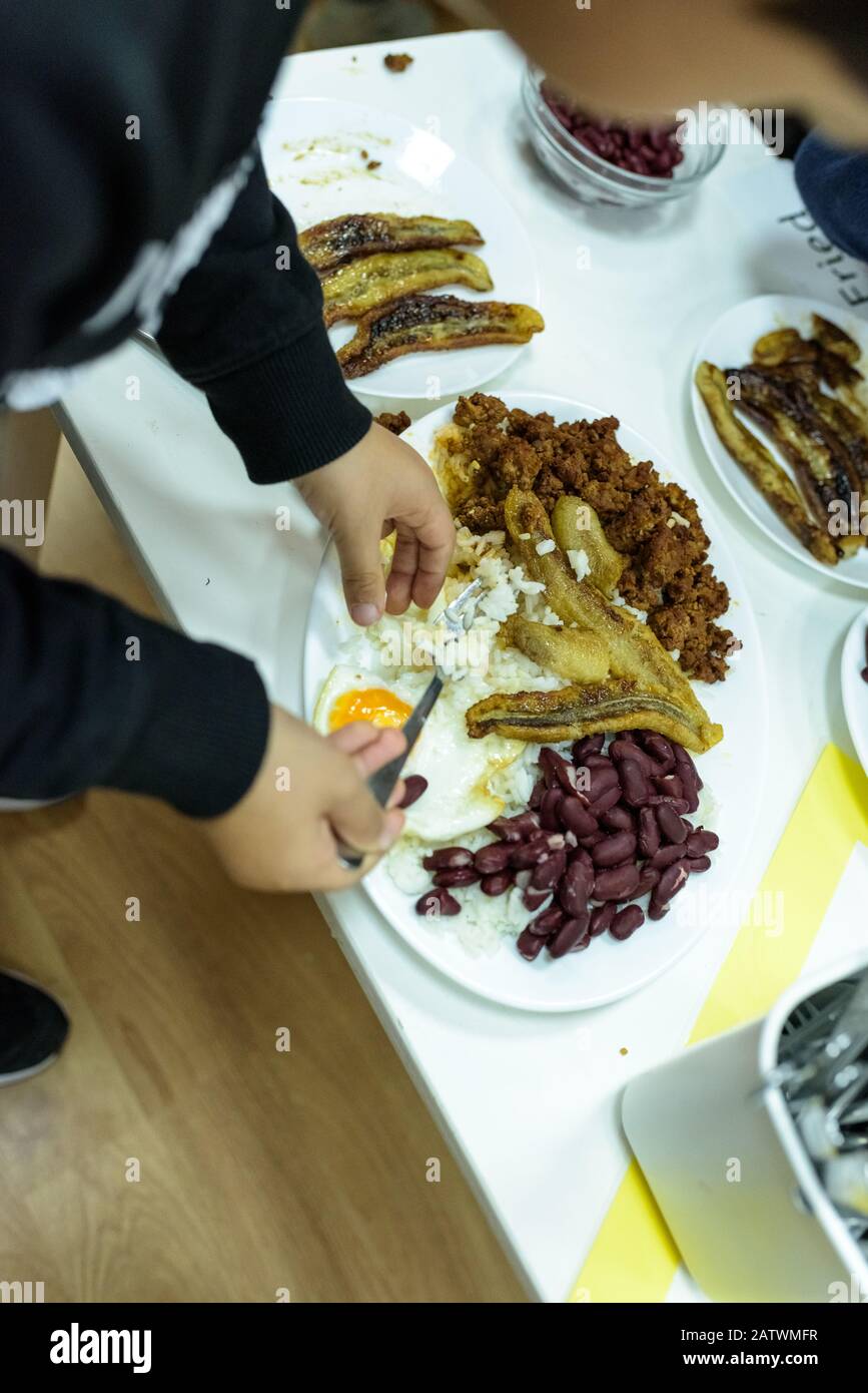 Children eating the typical Colombian dish Bandeja Paisa Stock Photo ...