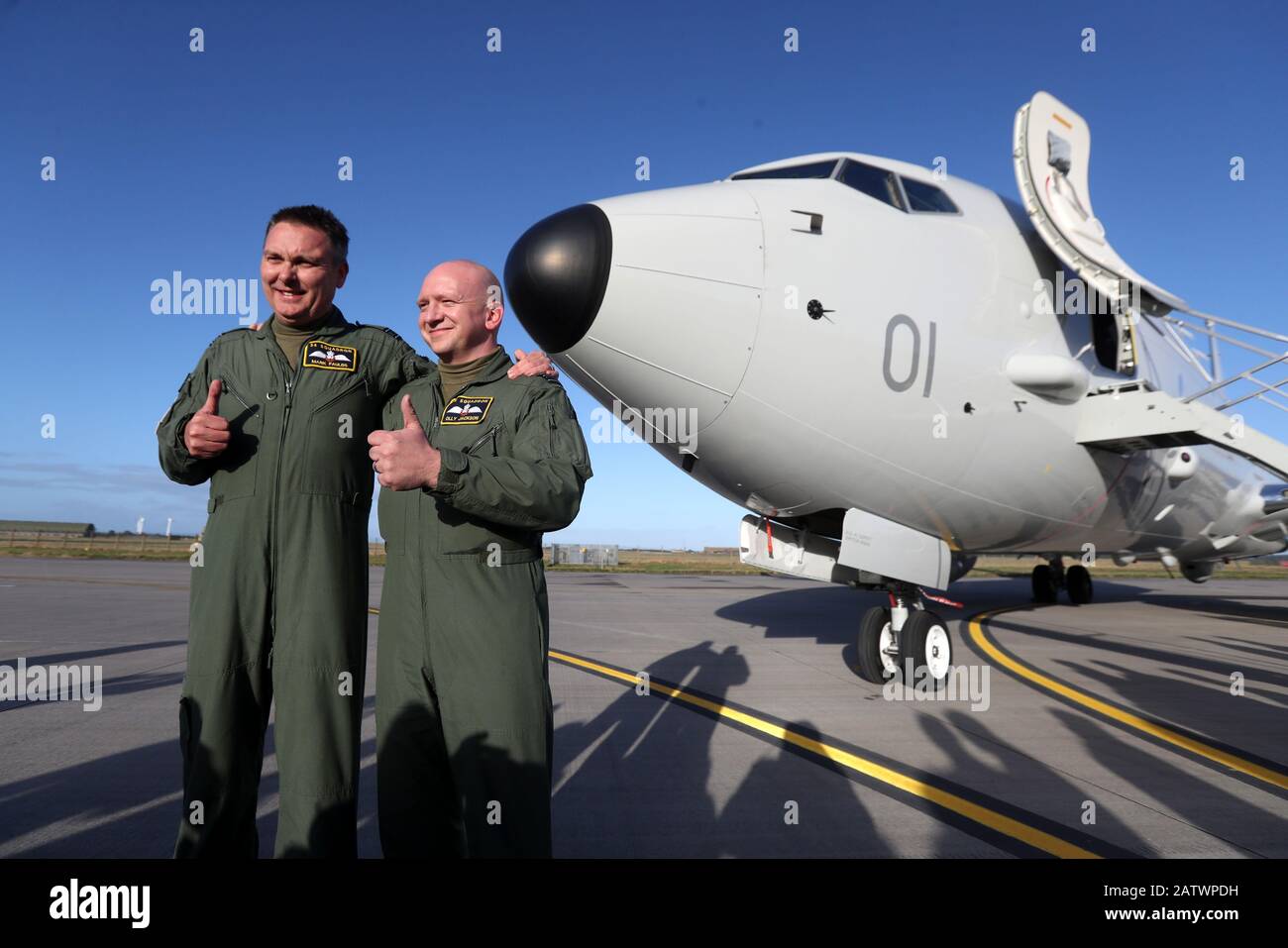 Squadron Leader Mark Faulds ( left) poses for a photograph at Kinloss ...