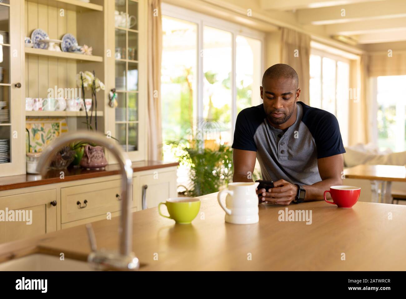African in kitchen with phone hi-res stock photography and images - Alamy