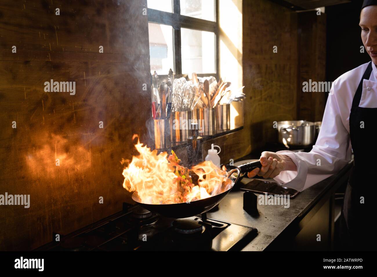 Cook working flaming pan hi-res stock photography and images - Alamy