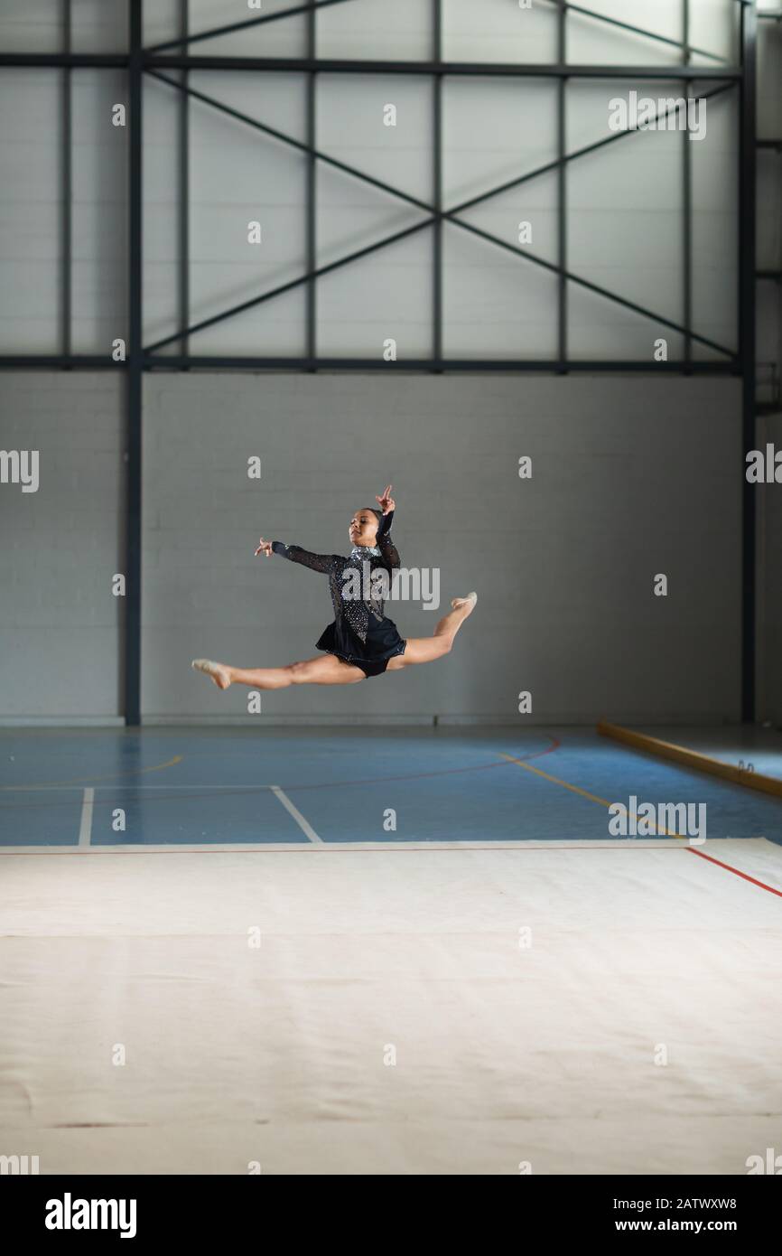 Gymnast jumping at the gym Stock Photo - Alamy