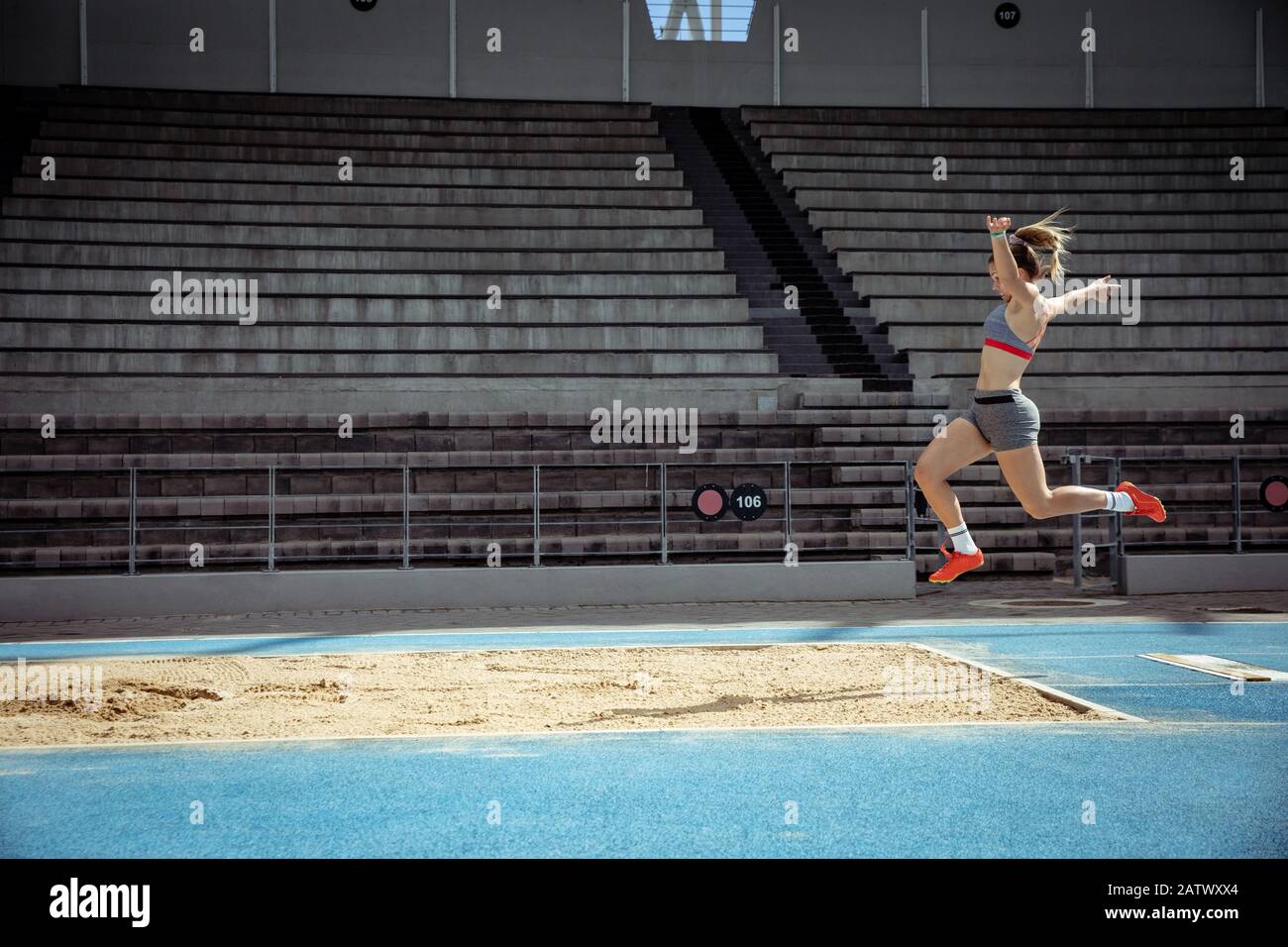 Athlete doing a long jump Stock Photo - Alamy