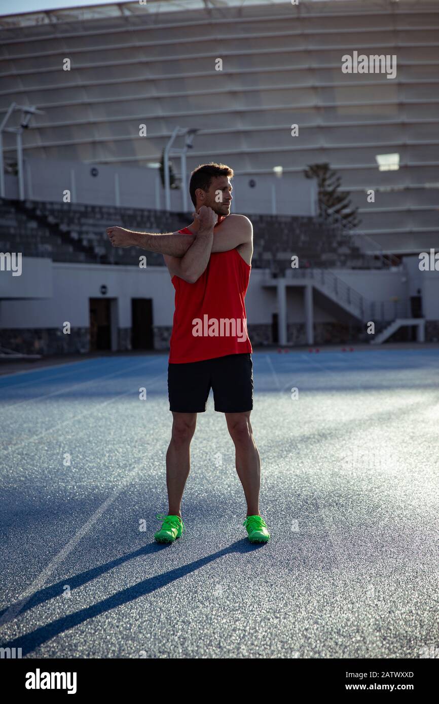 Athlete stretching at the stadium Stock Photo - Alamy