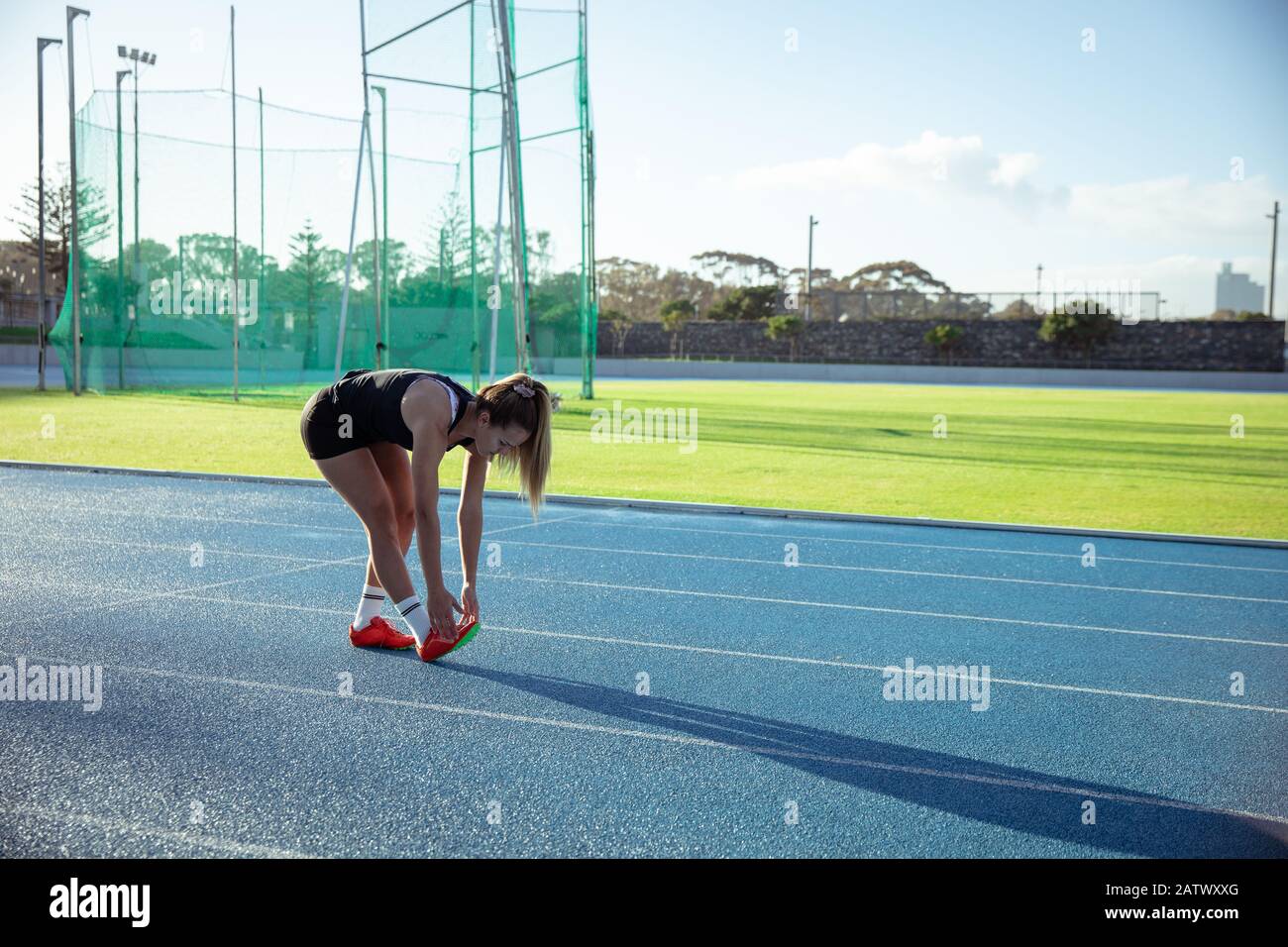Athlete stretching at the stadium Stock Photo - Alamy