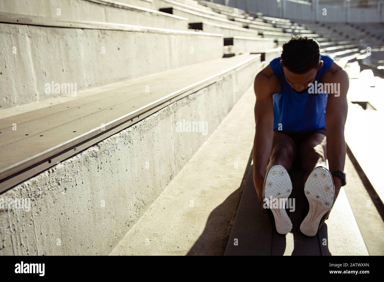 Athlete stretching at the stadium Stock Photo - Alamy