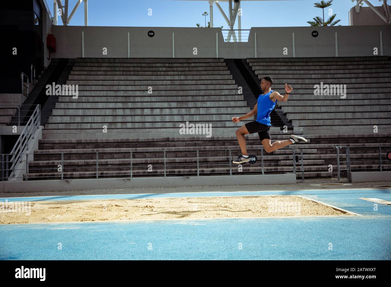 Athlete doing a long jump Stock Photo - Alamy