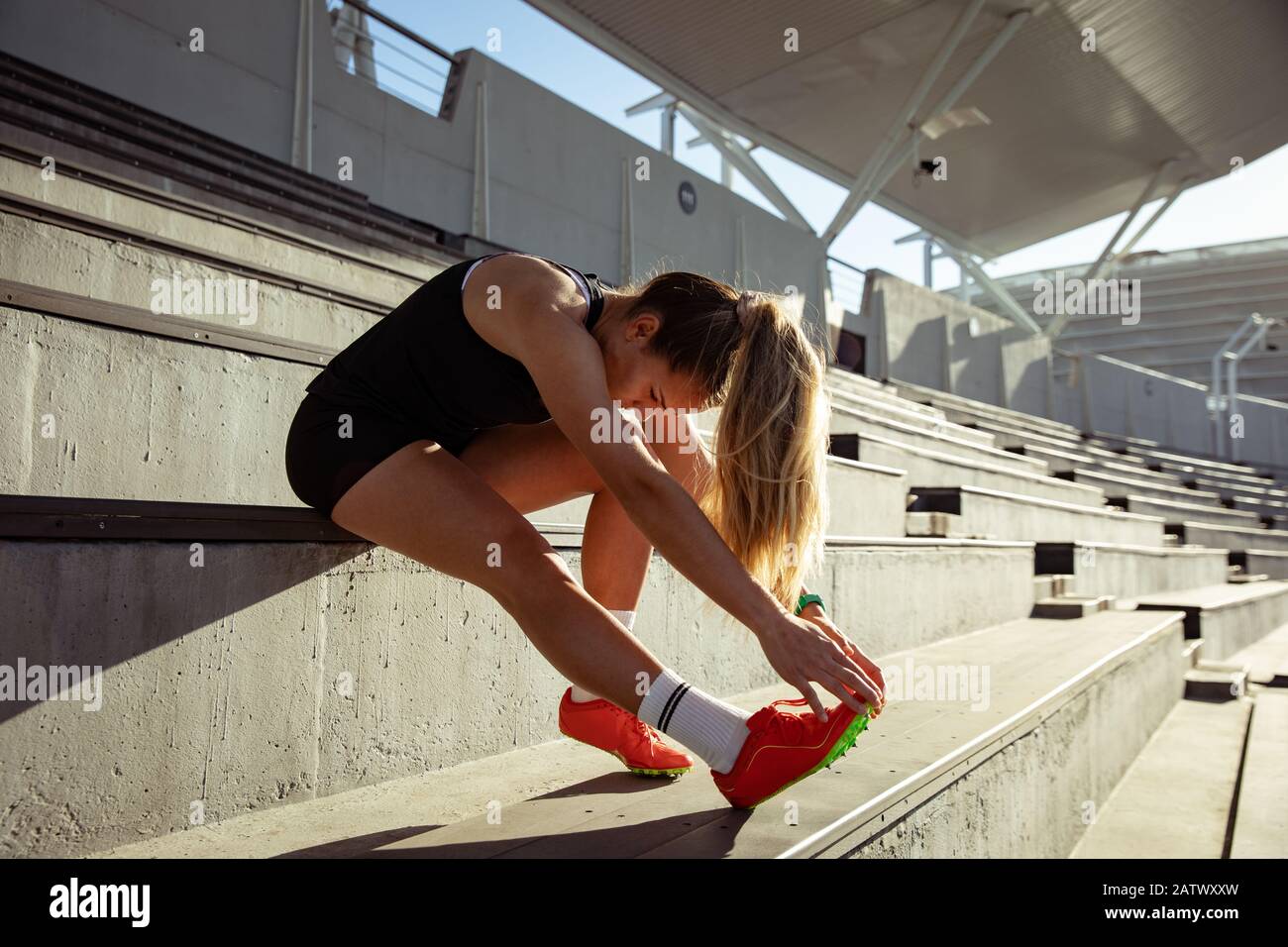 Athlete stretching at the stadium Stock Photo - Alamy