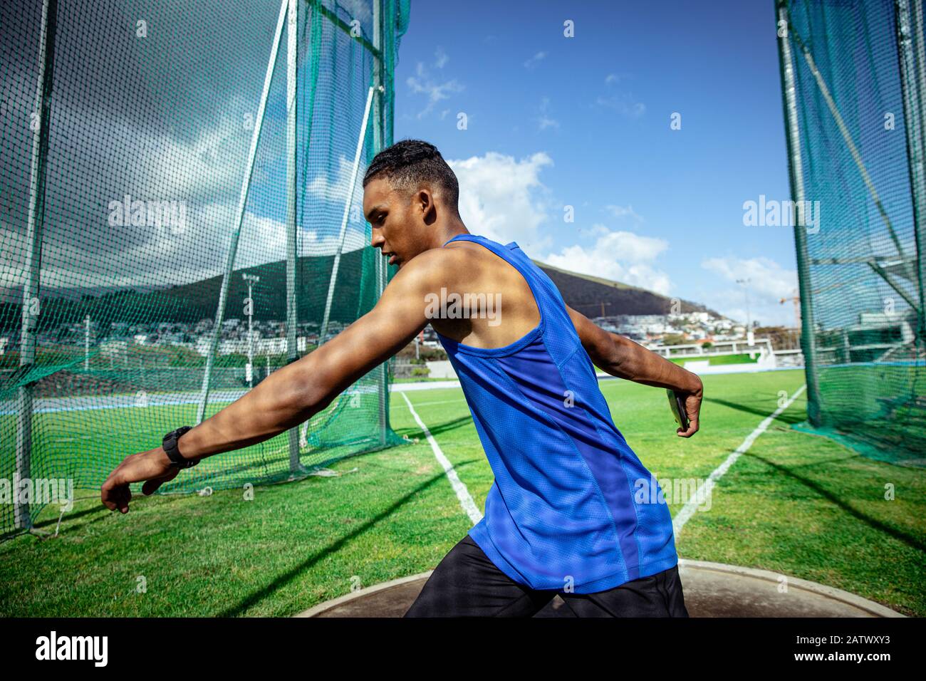 Athlete throwing a disc in a stadium Stock Photo - Alamy