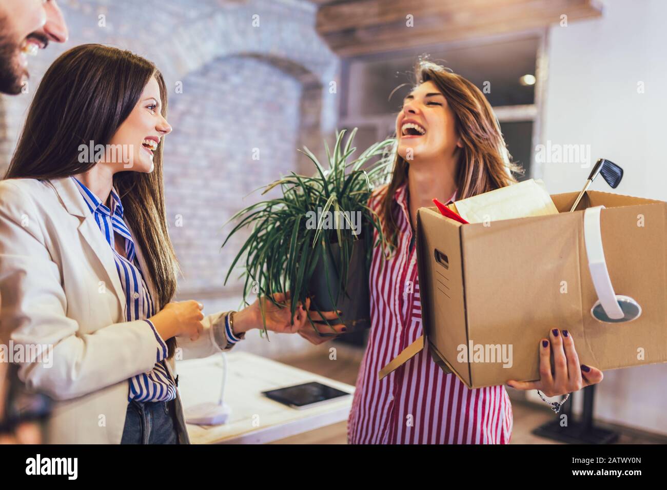 Woman having first working day getting in modern office, holding with ...
