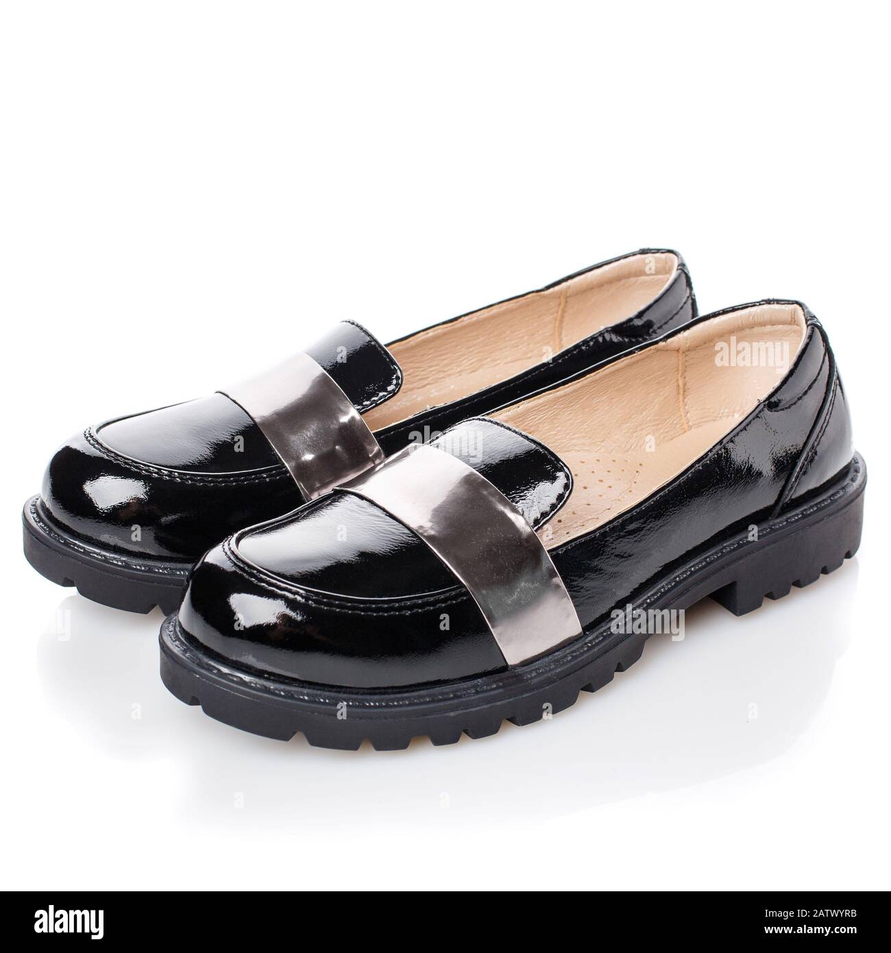 Lacquered shoes with silver inserts for girls isolated on white. Side ...