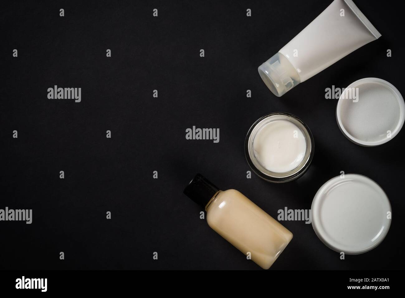 Natural cosmetics on black background Stock Photo - Alamy