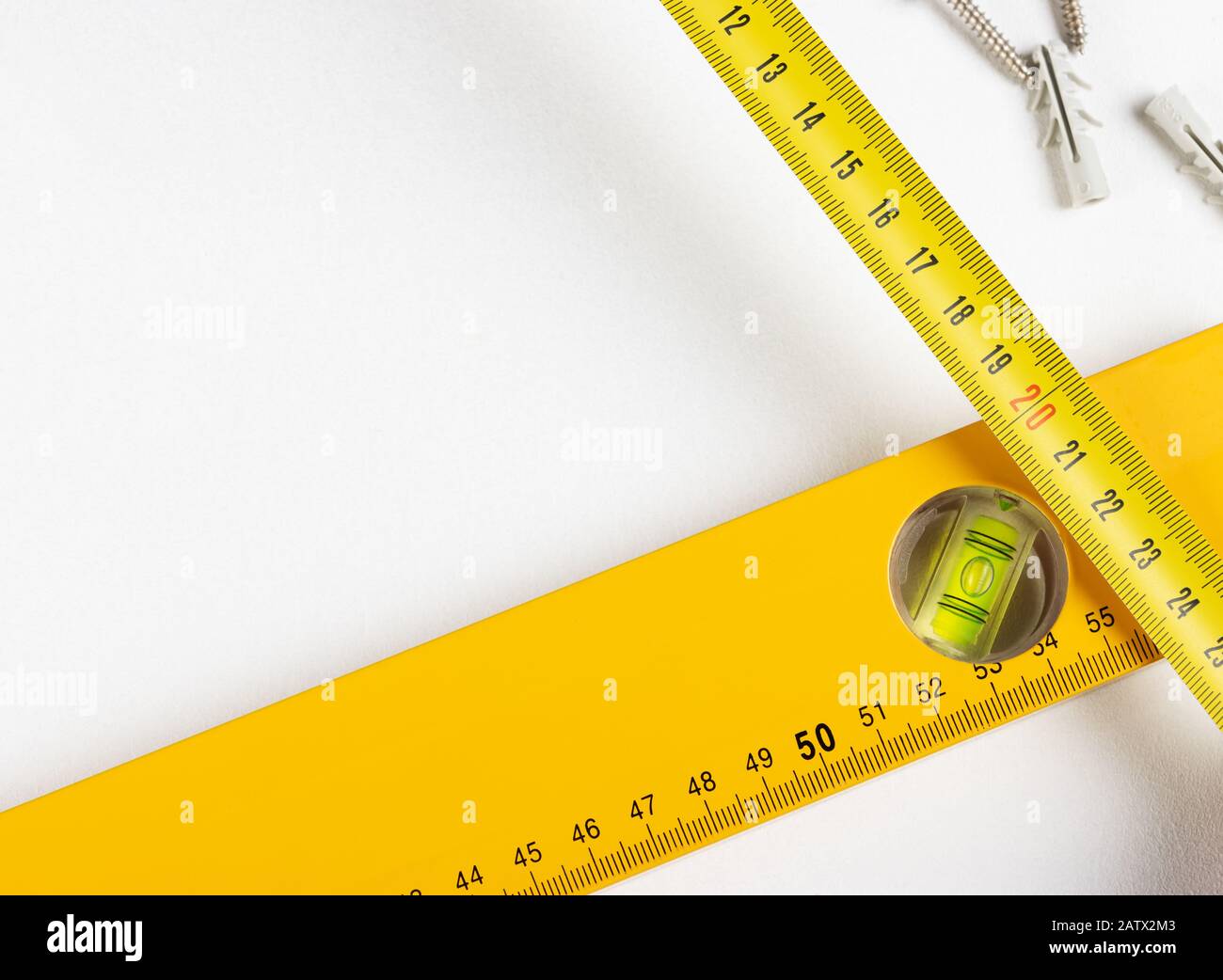 Yellow tape measure spirit level and scaffolding dowels and self ...