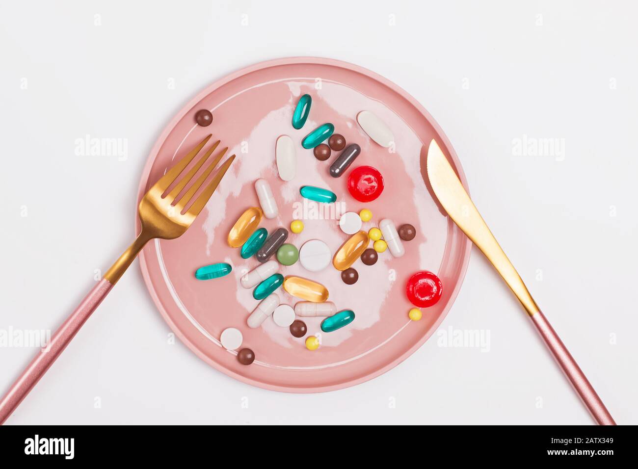 A plate full of capsules and tablets of different shapes and sizes with ...
